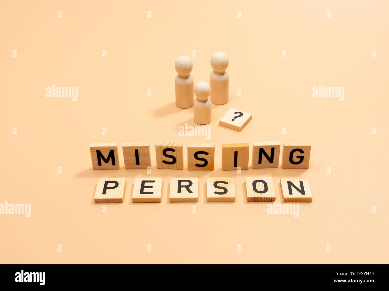 A group of people made of wooden figures. The group stands in front of ...