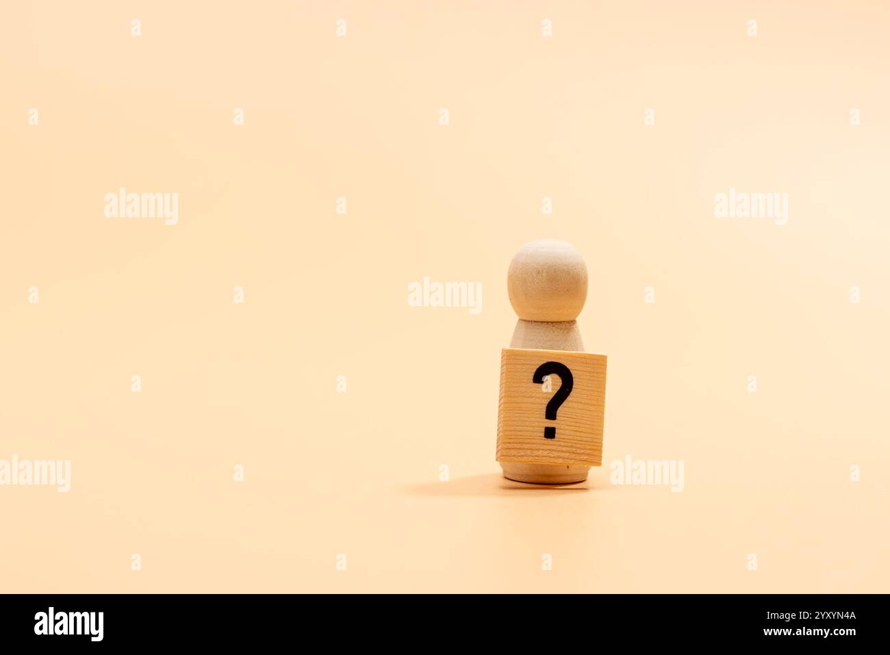 Wooden figure with a question mark. Concept of curiosity and uncertainty and finding yourself ...
