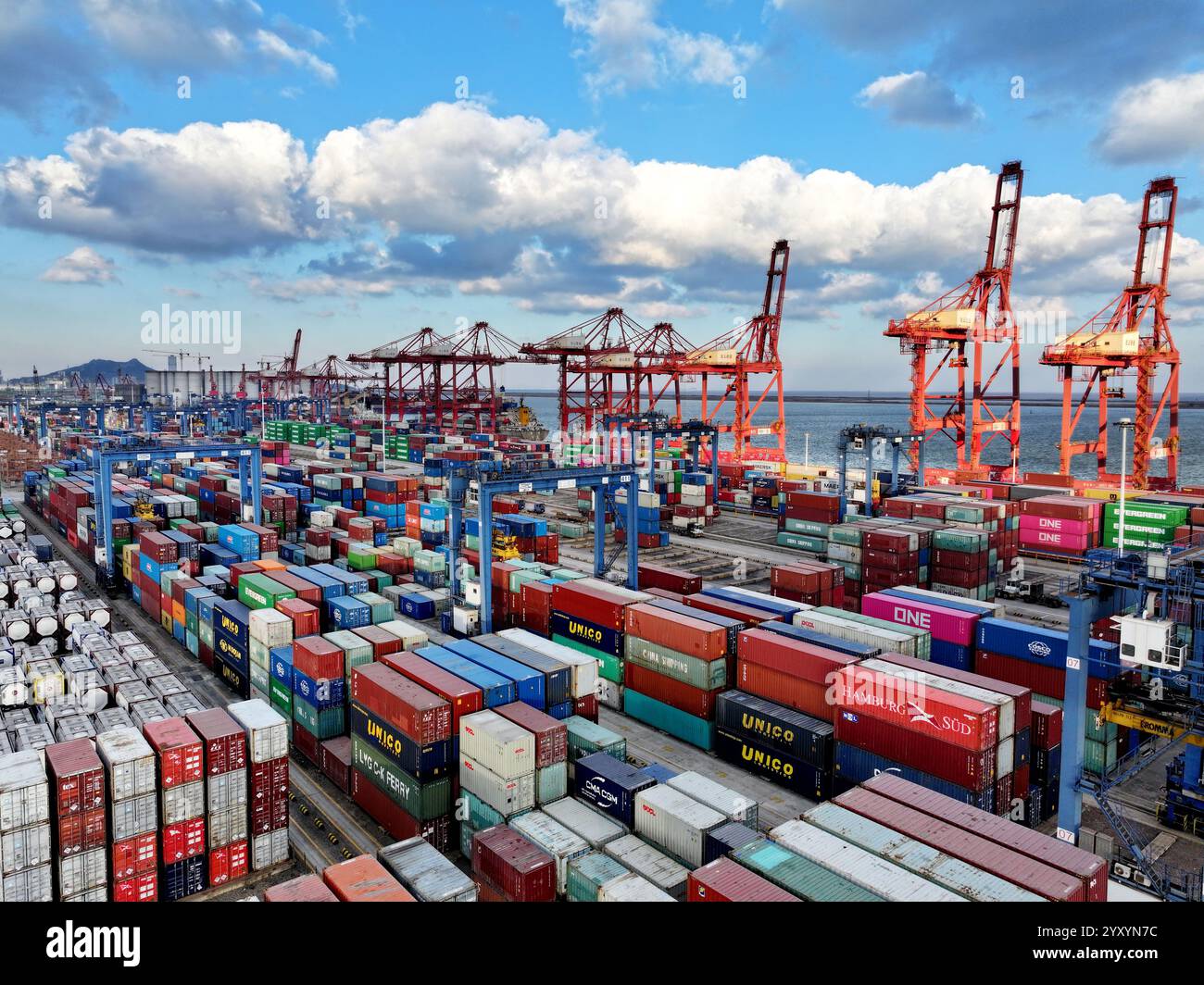 LIANYUNGANG, CHINA - DECEMBER 18, 2024 - Cargo ships stop at their ...
