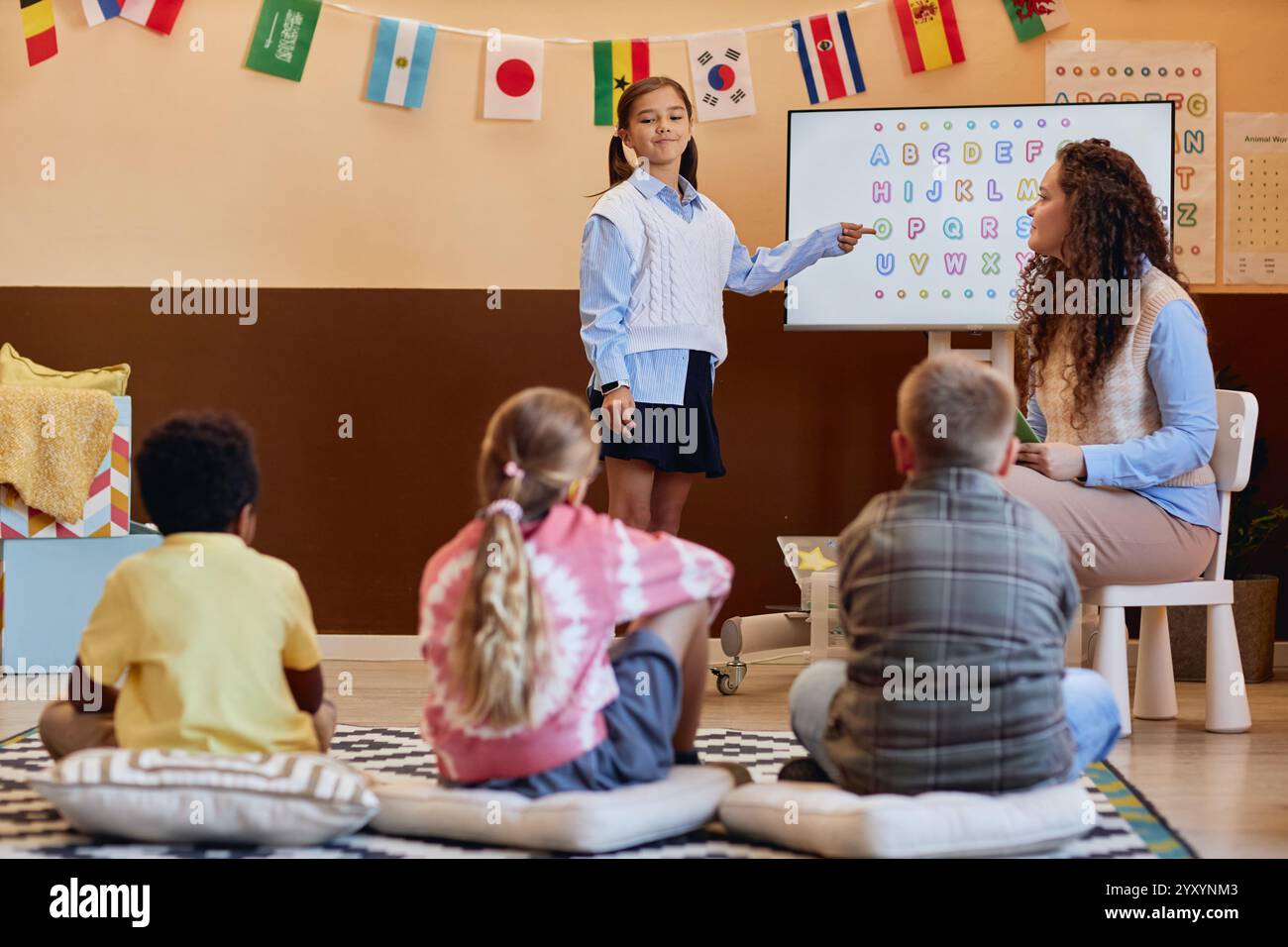 Full length portrait of young girl answering question standing in front ...