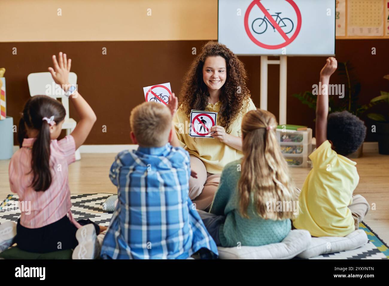 Front view of young female teacher holding road safety cards and ...