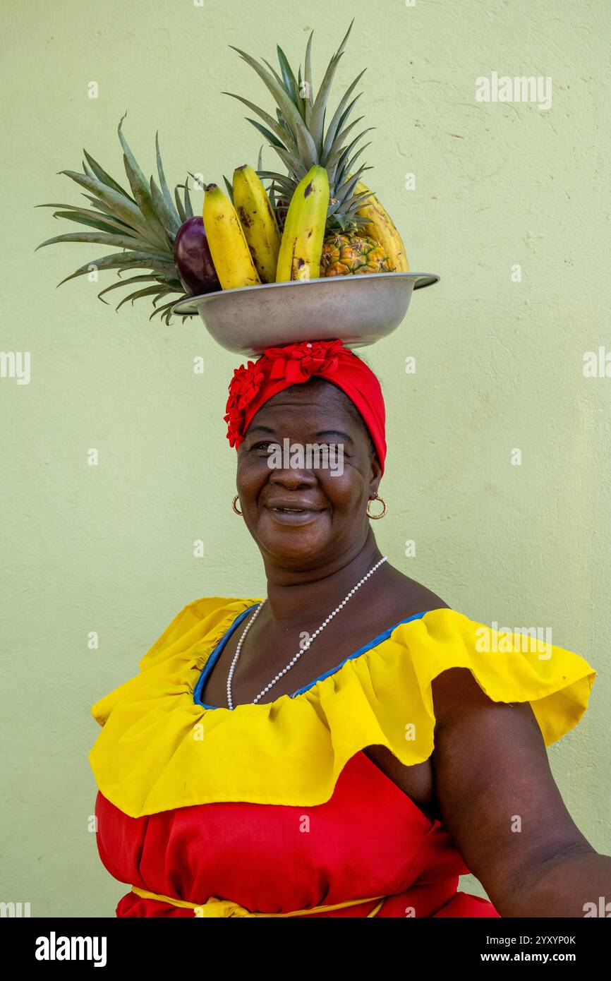 A Palenquera Woman Wearing A Bright Traditional Dress With A Fruit ...