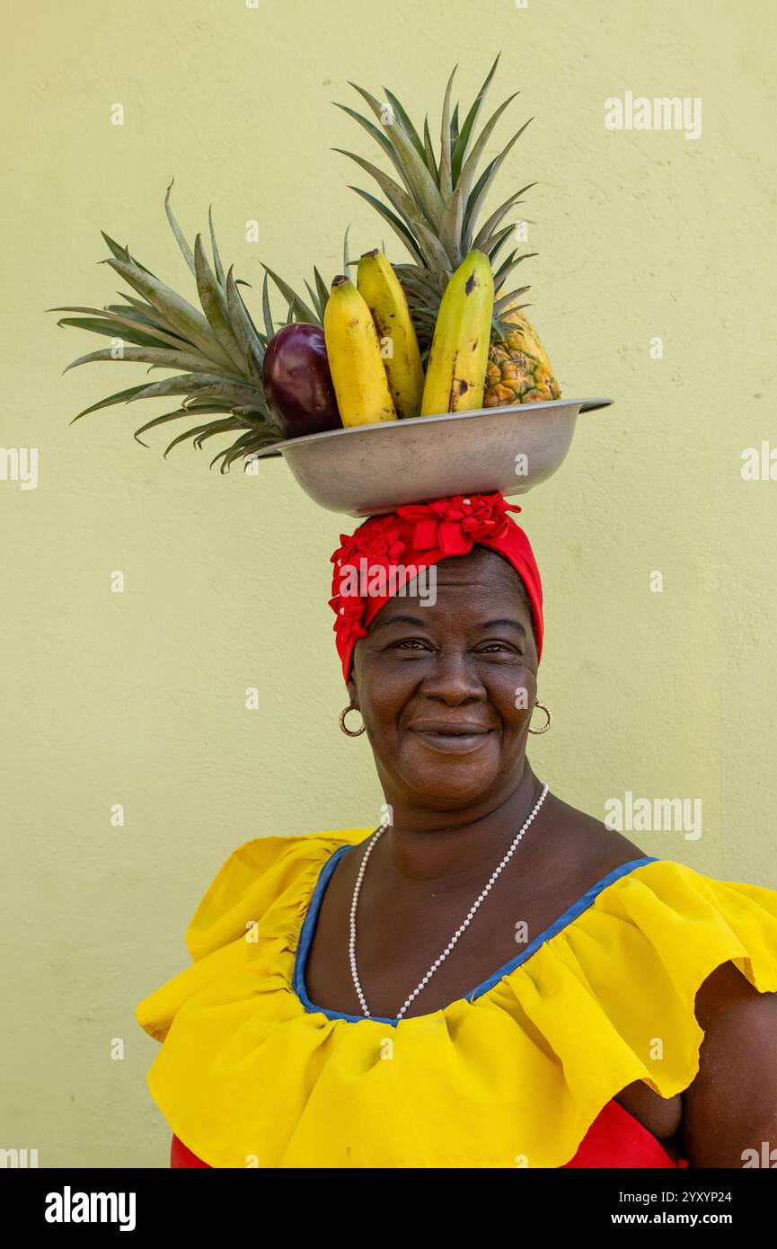 A Palenquera Woman Wearing A Bright Traditional Dress With A Fruit ...