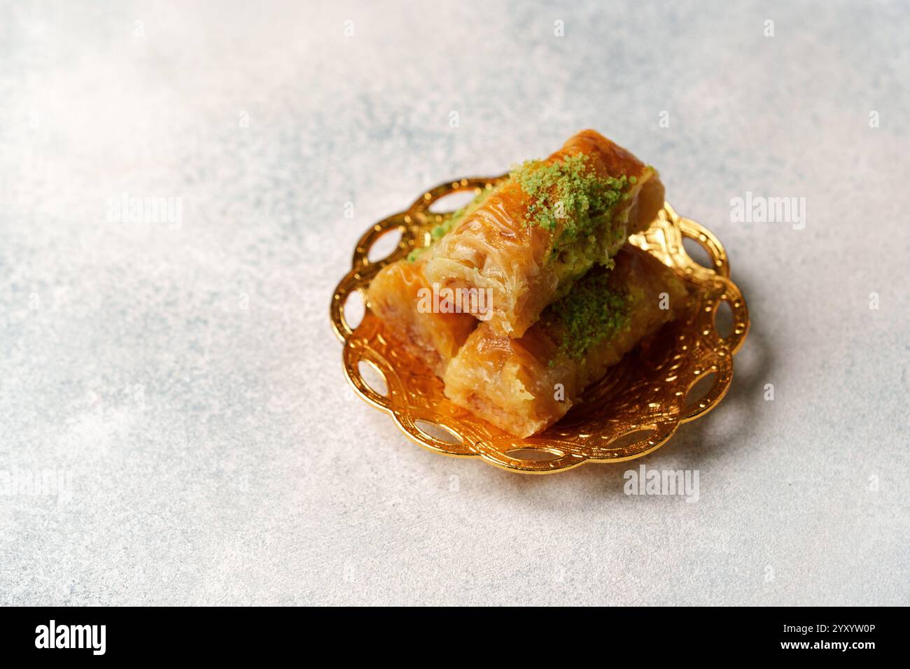 Delicious baklava served on an ornate gold tray showcasing its rich ...
