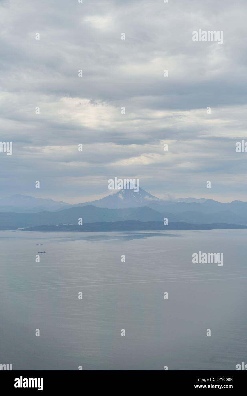A Majestic Vilyuchinsky volcano in Kamchatka Towers over Calm Waters ...
