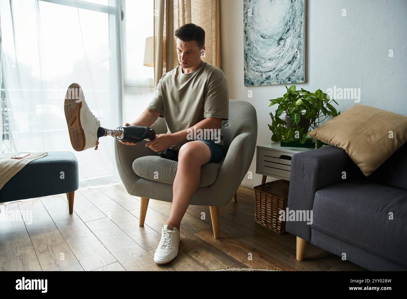 Man seated comfortably in a chair, making adjustments to his prosthetic ...