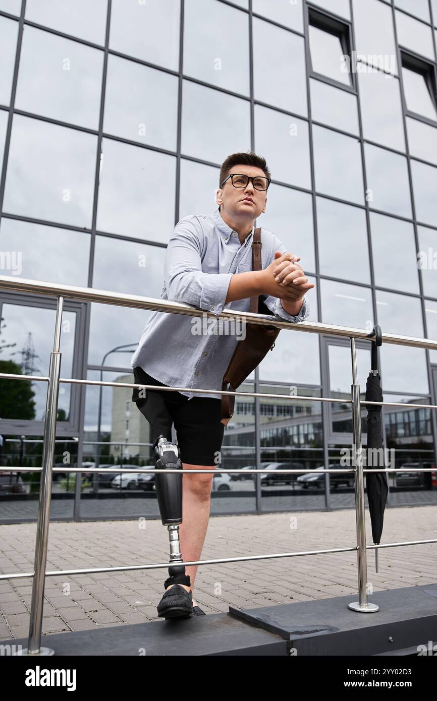 Young man with prosthetic leg stands confidently by a railing at a ...