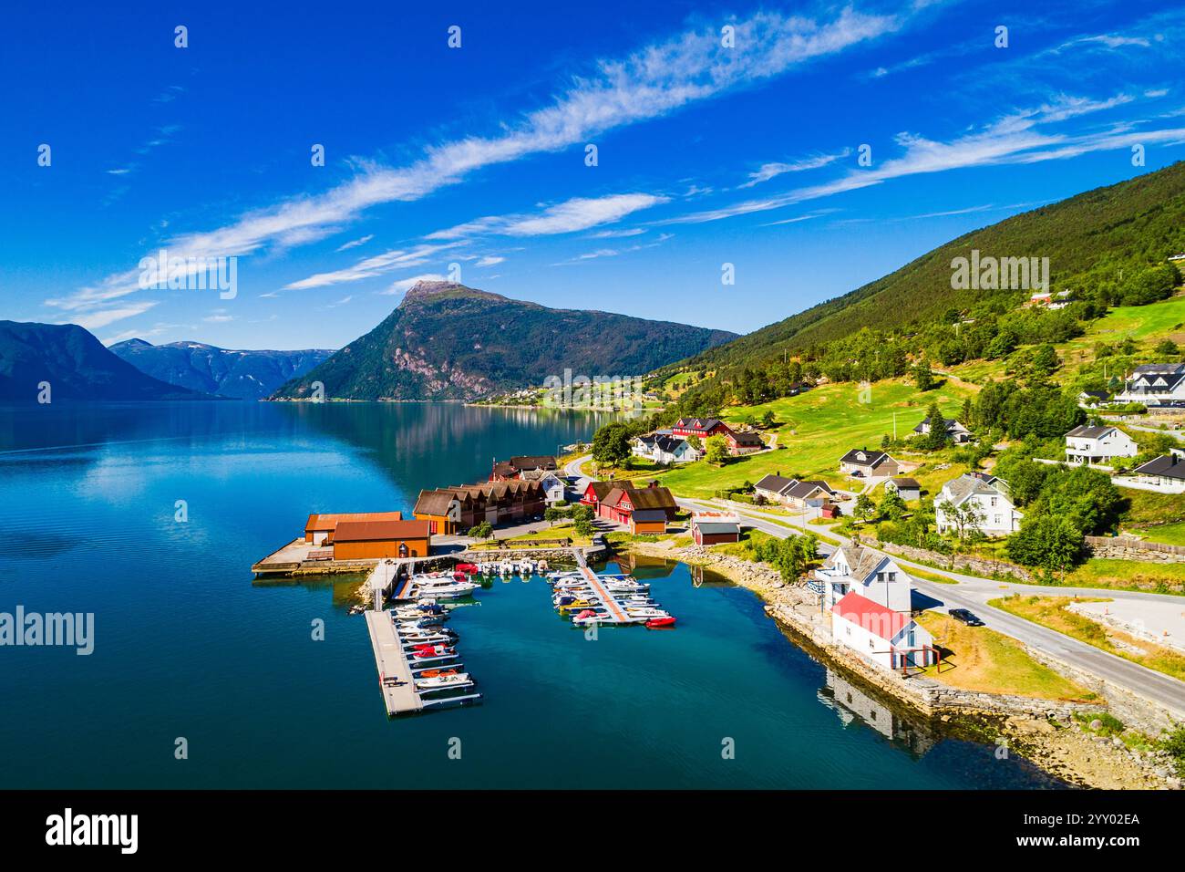 Crystal clear waters reflect the striking landscape of Norway, where a ...