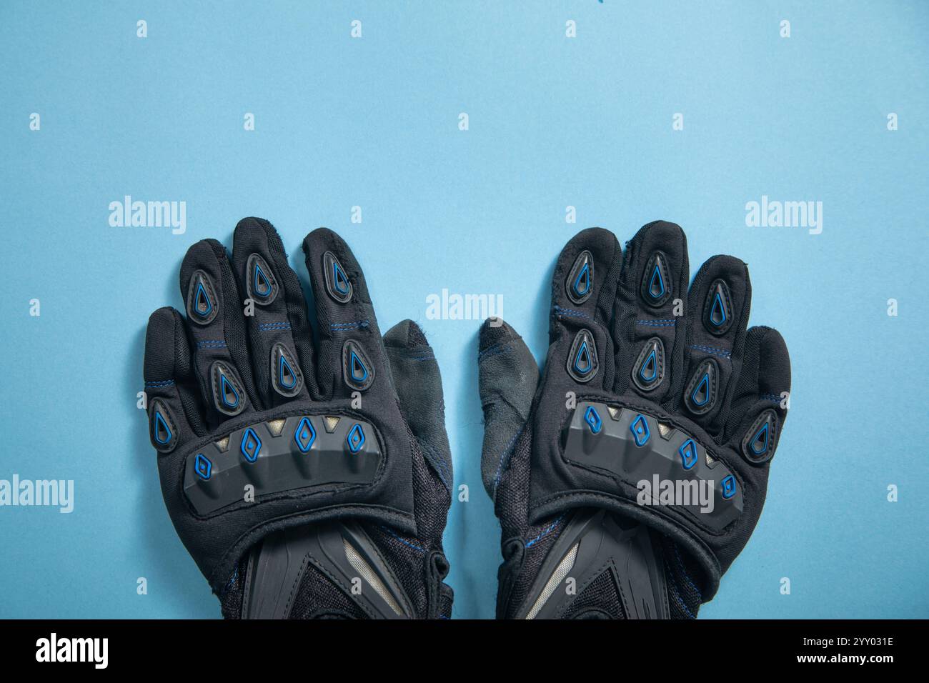 Motorcycle gloves on the blue background Stock Photo - Alamy