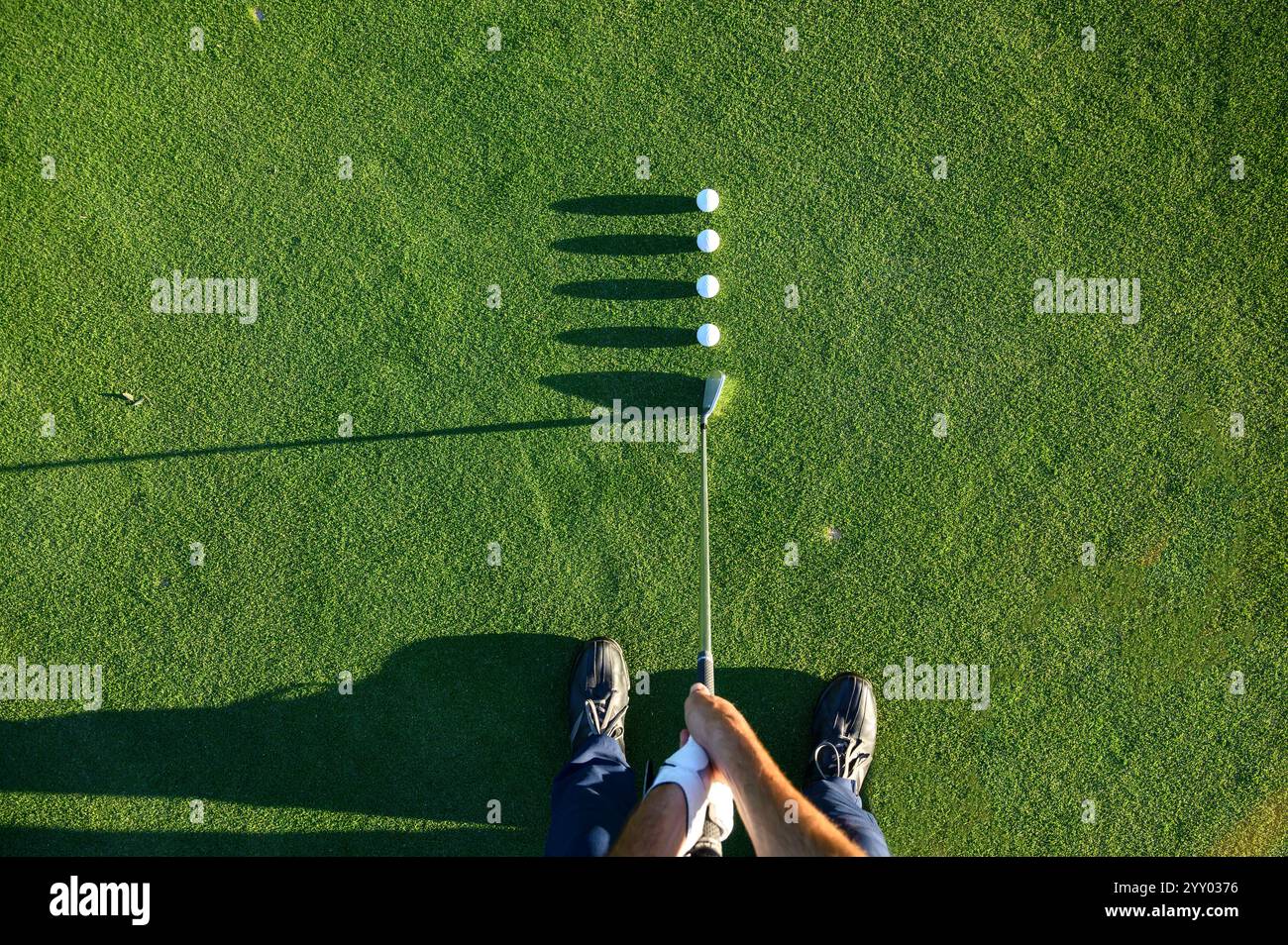 Golf balls in line while putting for accuracy Stock Photo - Alamy