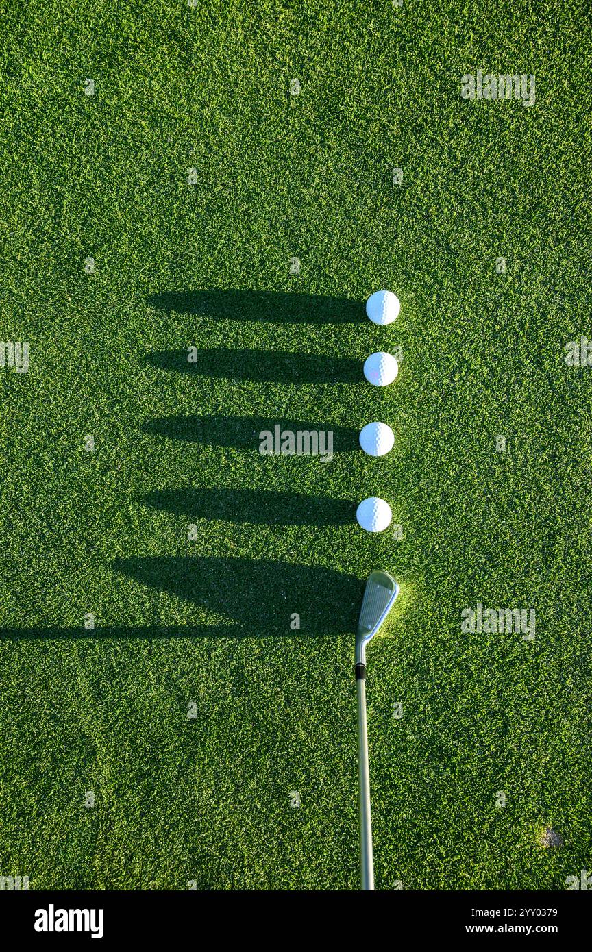 Golf balls in line while putting for accuracy Stock Photo - Alamy