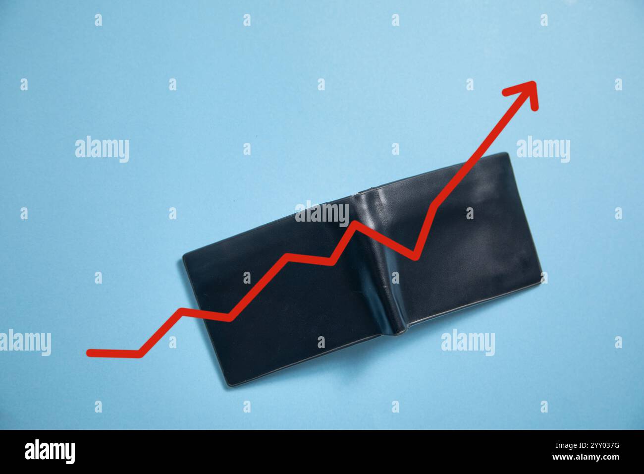 Wallet with a red arrow on the blue background Stock Photo - Alamy