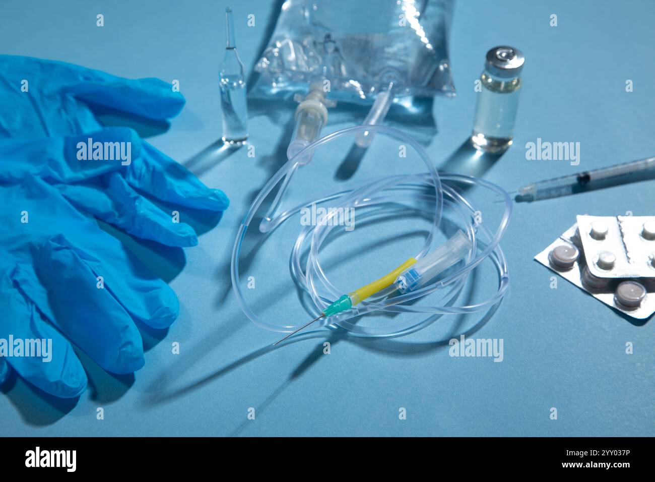Infusion bag, syringe, medical ampoules in the blue background. IV drip ...