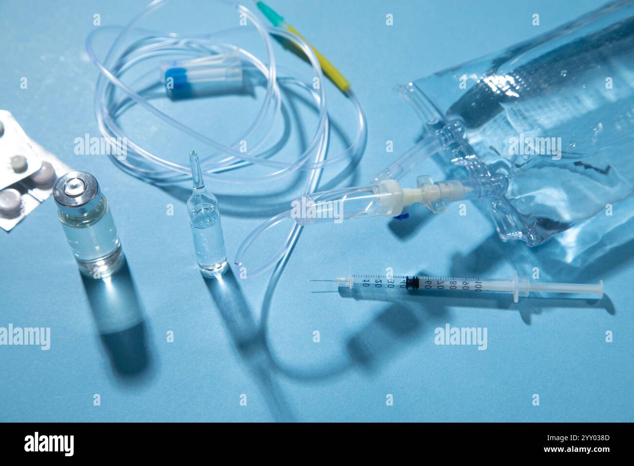 Infusion bag, syringe, medical ampoules in the blue background. IV drip ...