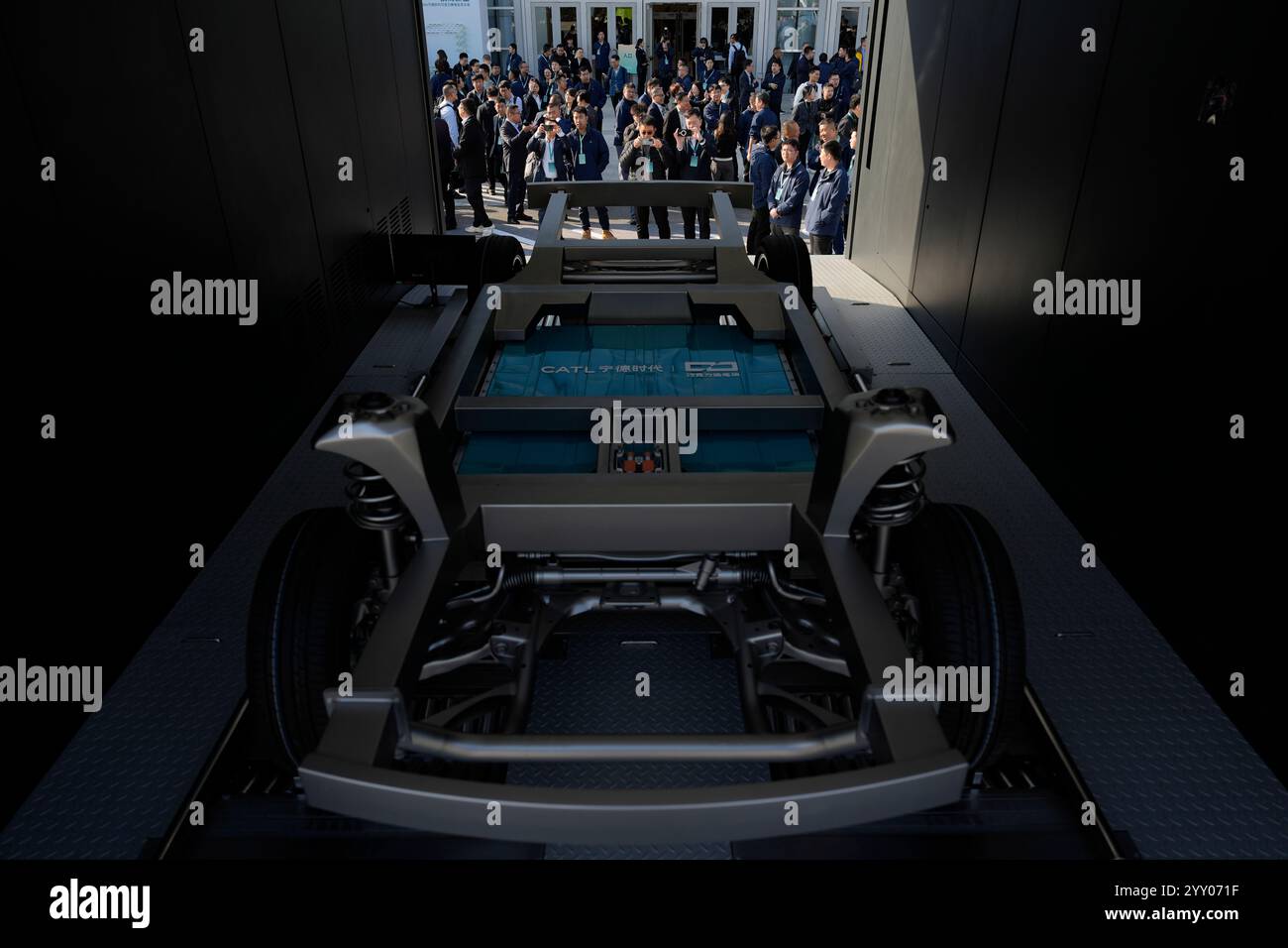 Attendees look at the next generation battery swapping station from China-based CATL, the world ...