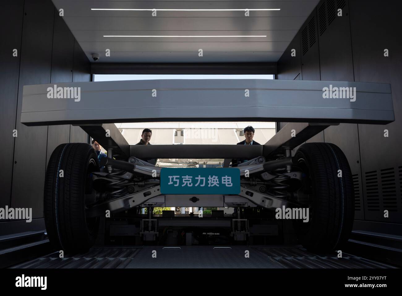 Attendees look at the next generation battery swapping station by China-based CATL battery ...