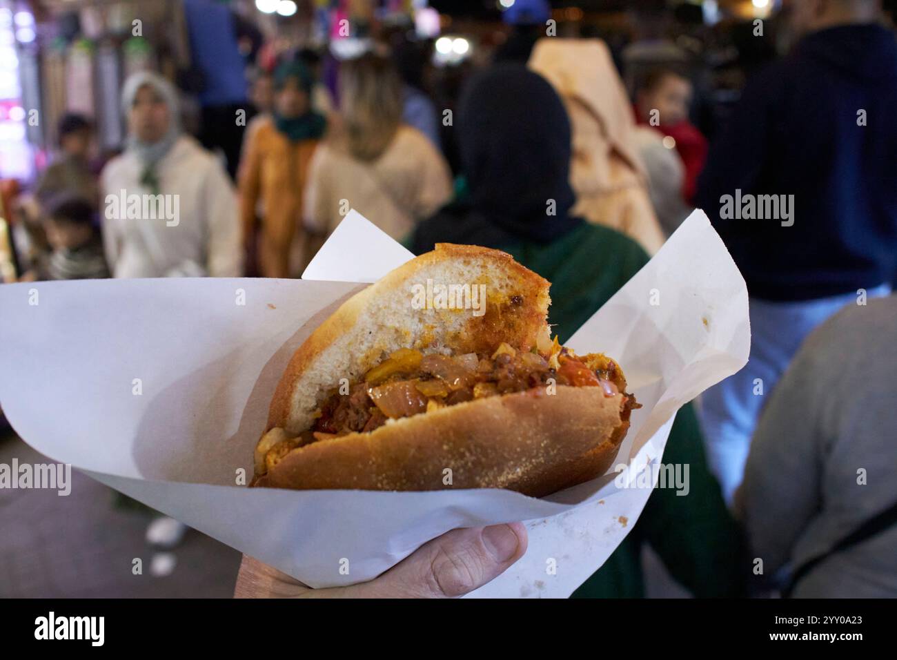 eating a mixed meat hot sandwich street food walking around the old ...