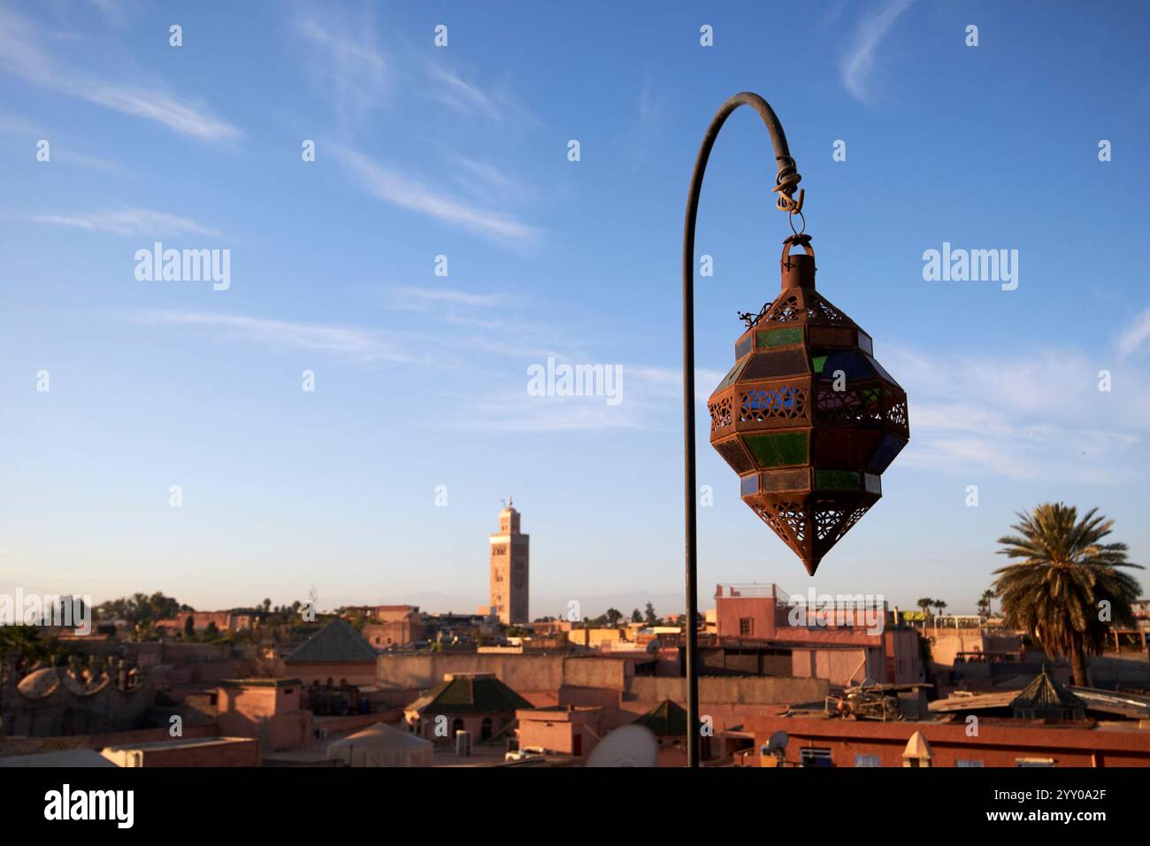 moroccan design glass and metal lamp hanging on city skyline with ...