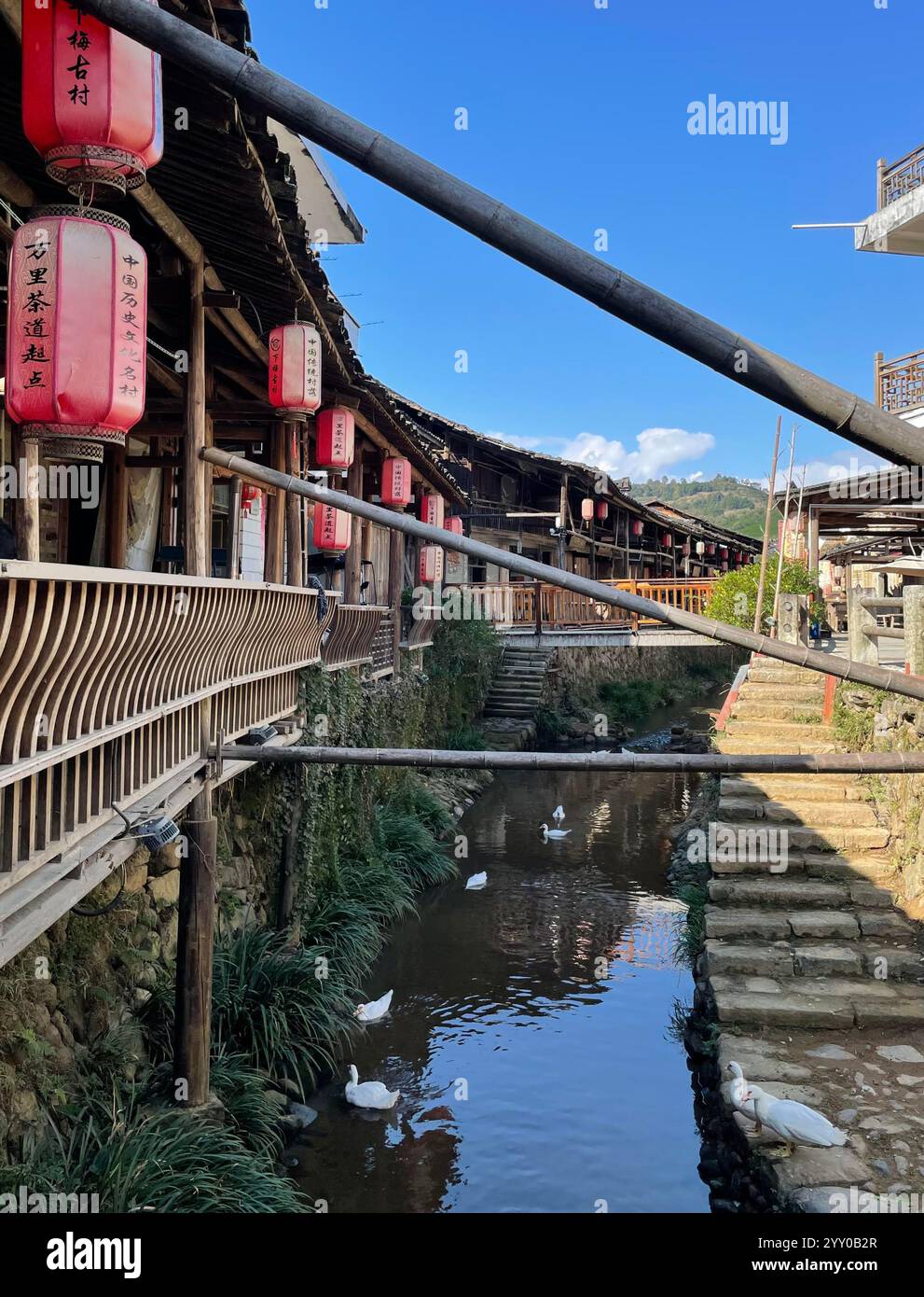 Traditional Chinese town with wooden structures in mountains with red ...
