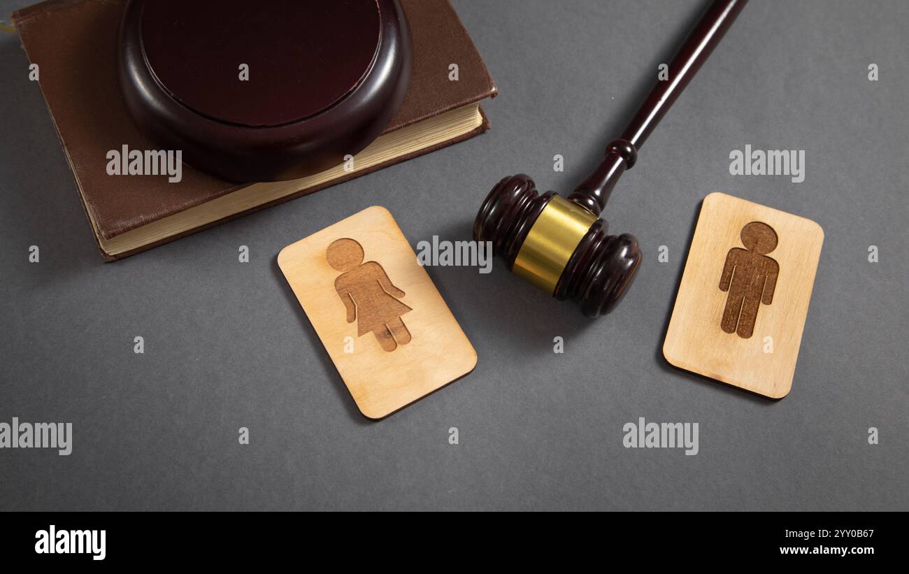 Judge gavel with a male and female wooden symbols on the black ...