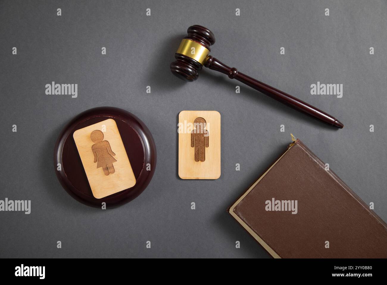 Judge gavel with a male and female wooden symbols on the black ...