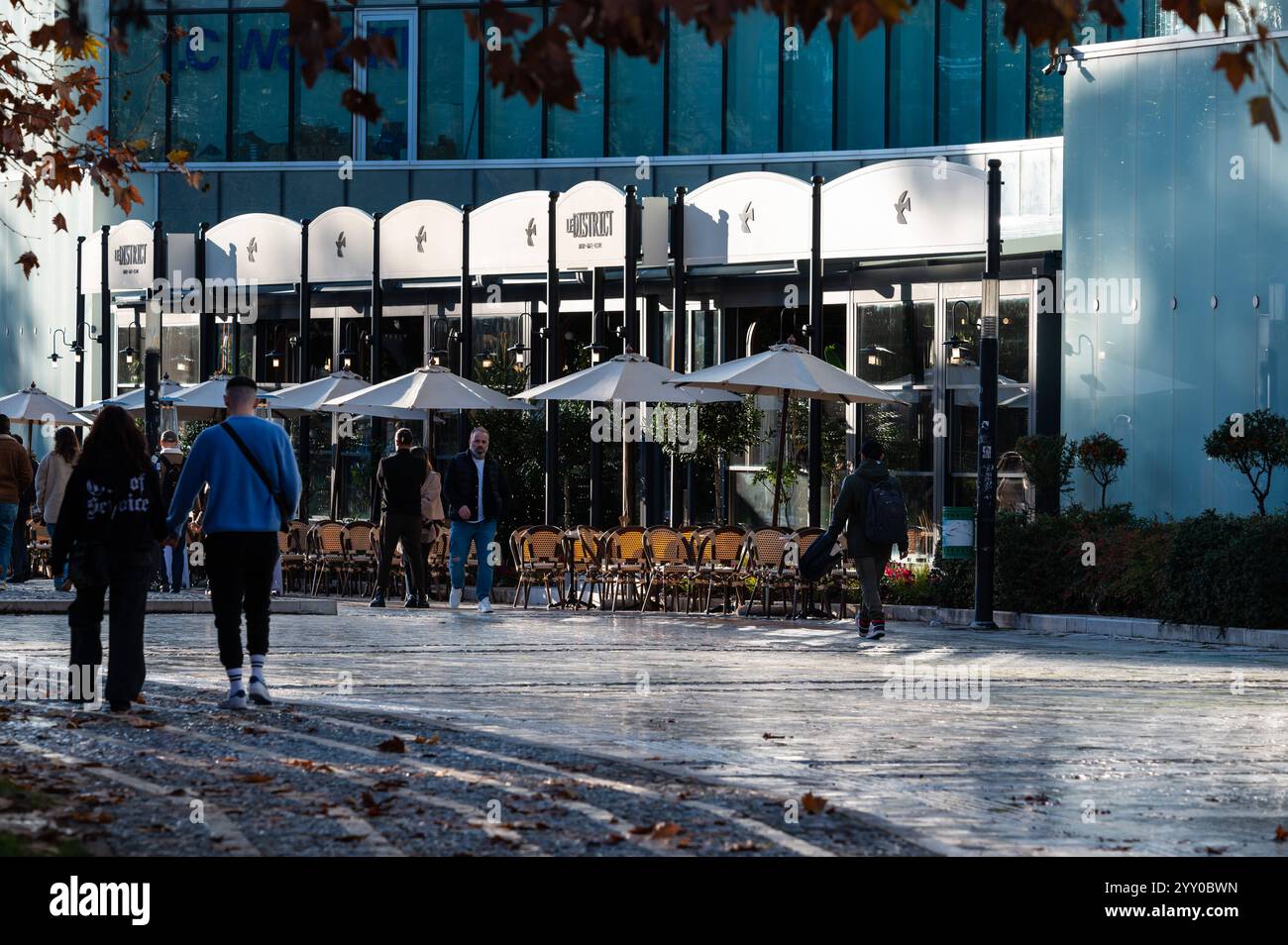 People walking at the park of the Toptani shopping center in Tirana ...