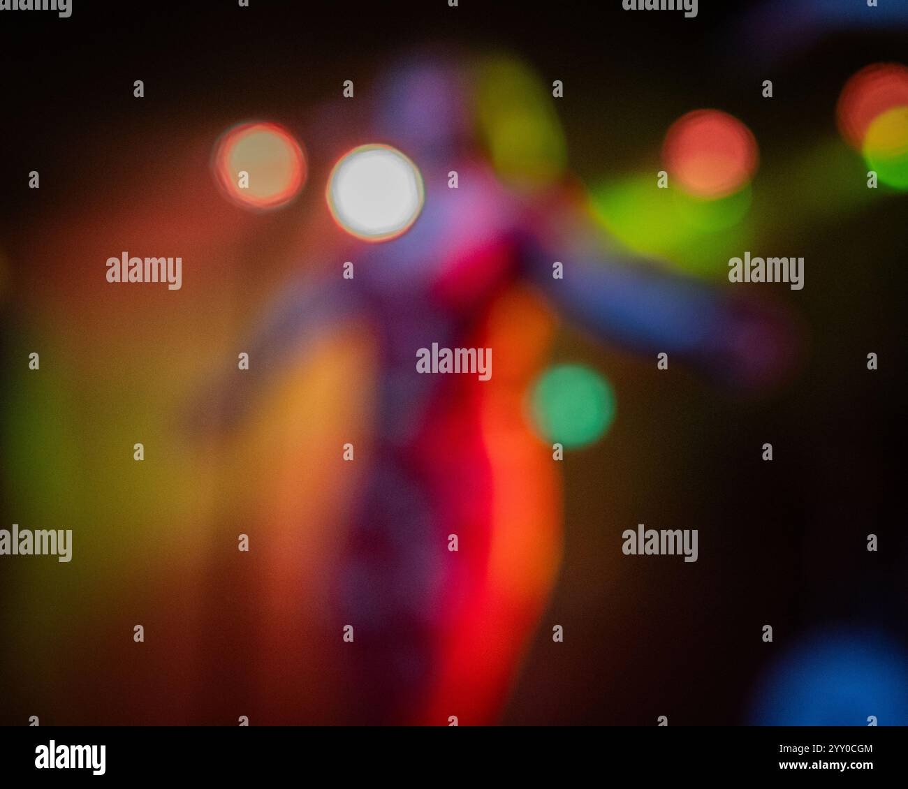 Person on Stage with multi-coloured lights Stock Photo - Alamy