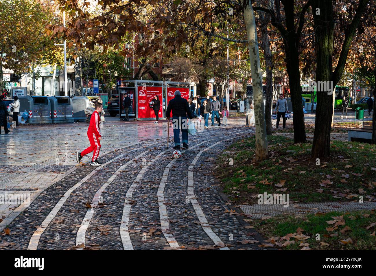 People walking at the park of the Toptani shopping center in Tirana ...