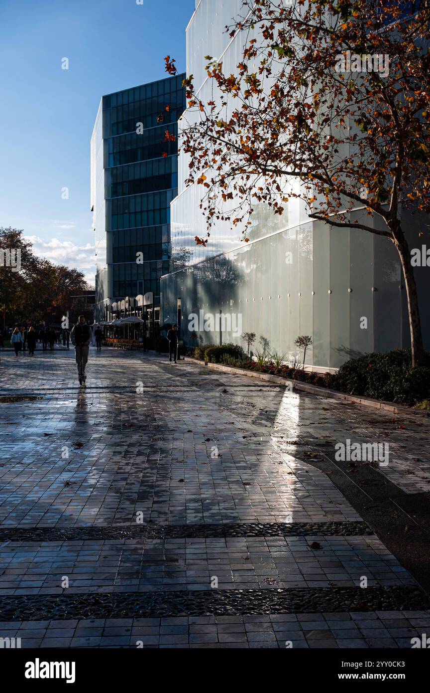 People walking at the park of the Toptani shopping center in Tirana ...