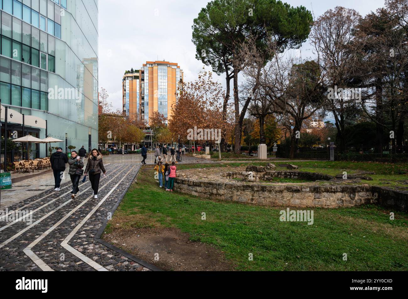 People walking at the park of the Toptani shopping center in Tirana ...