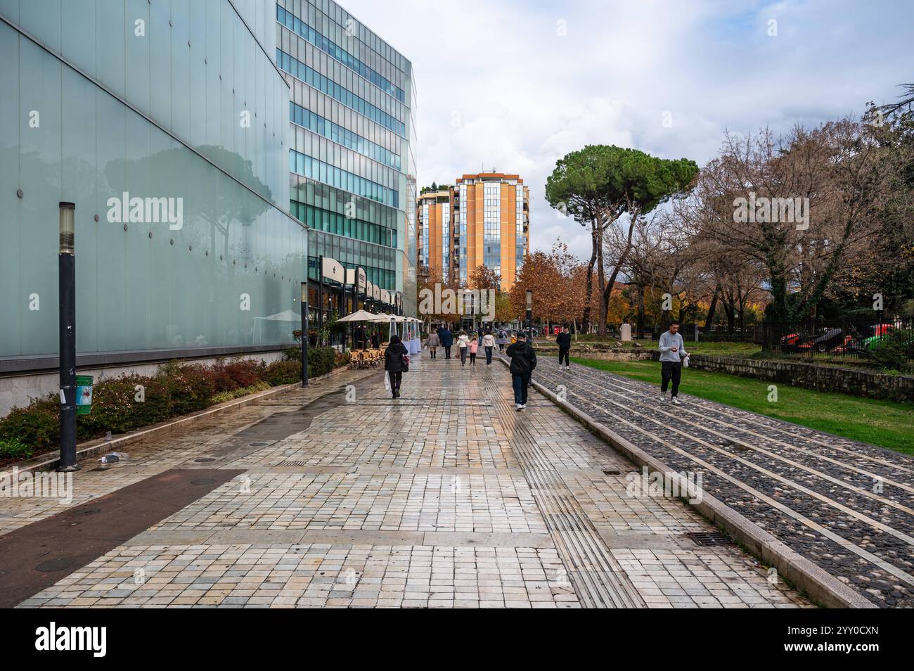 People walking at the park of the Toptani shopping center in Tirana ...