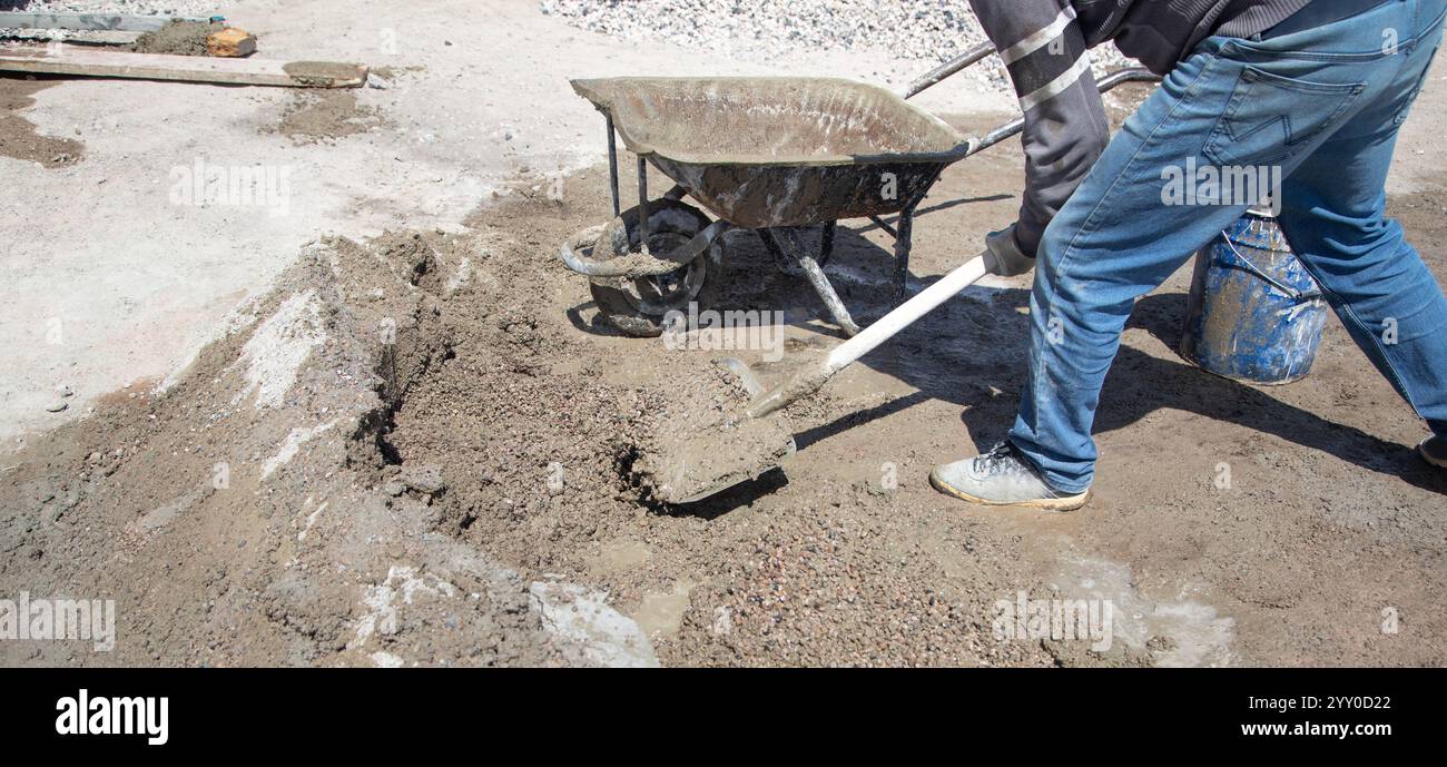 Worker prepare concrete with shovel at construction site Stock Photo ...