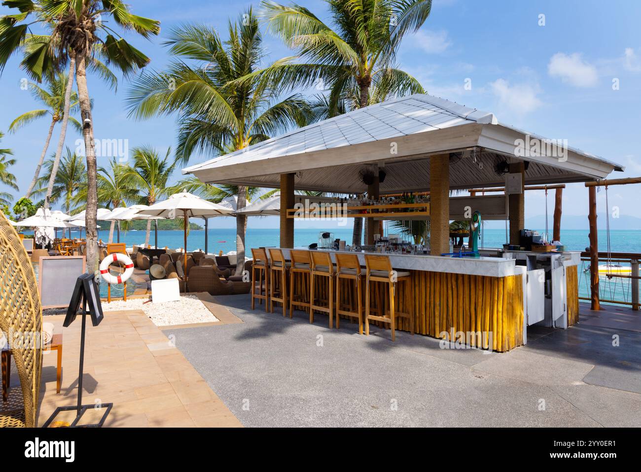 Beach bar surrounded by palm trees, offering a breathtaking view of the ...