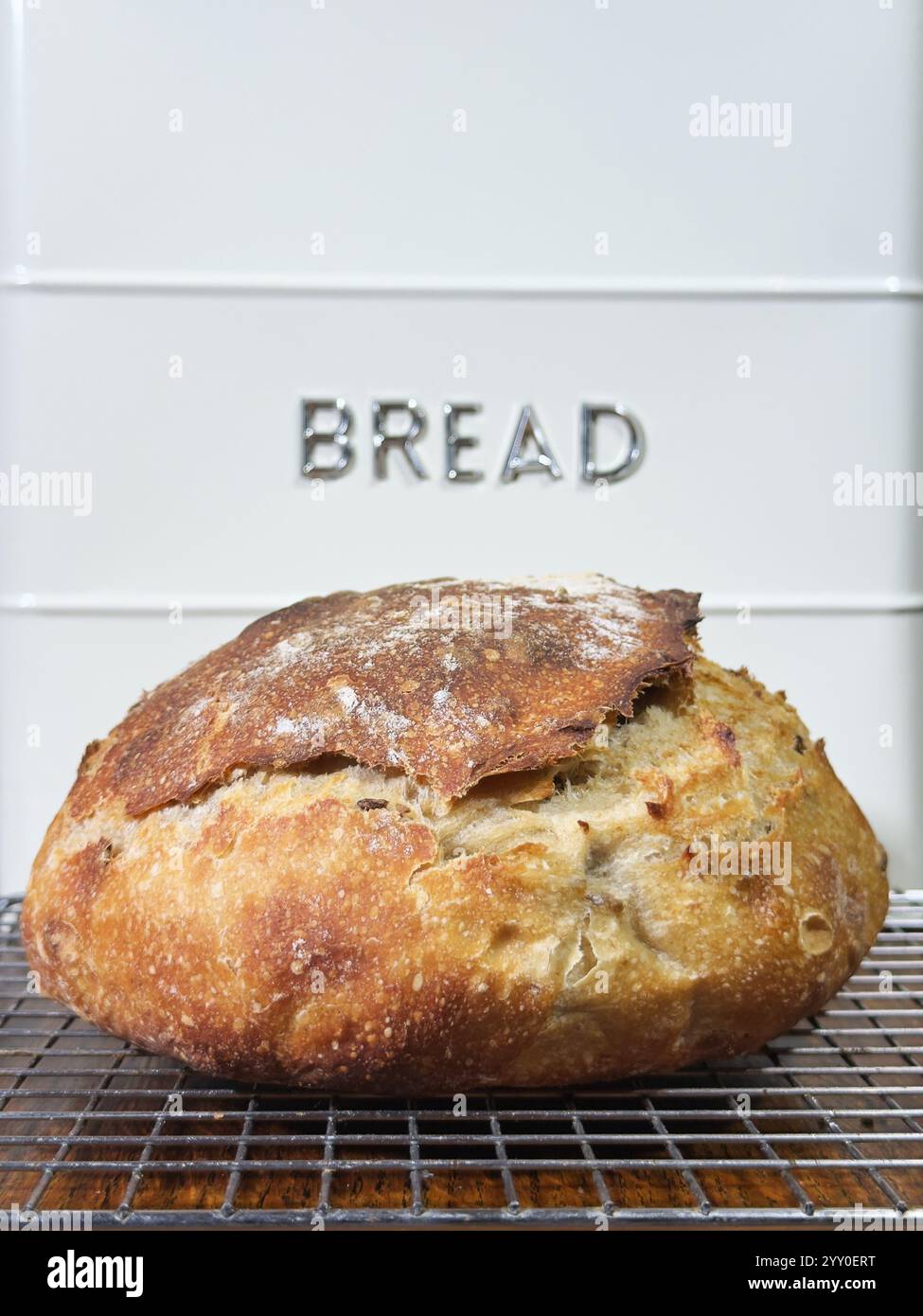 Closeup of a whole freshly baked loaf of homemade crusty sourdough ...