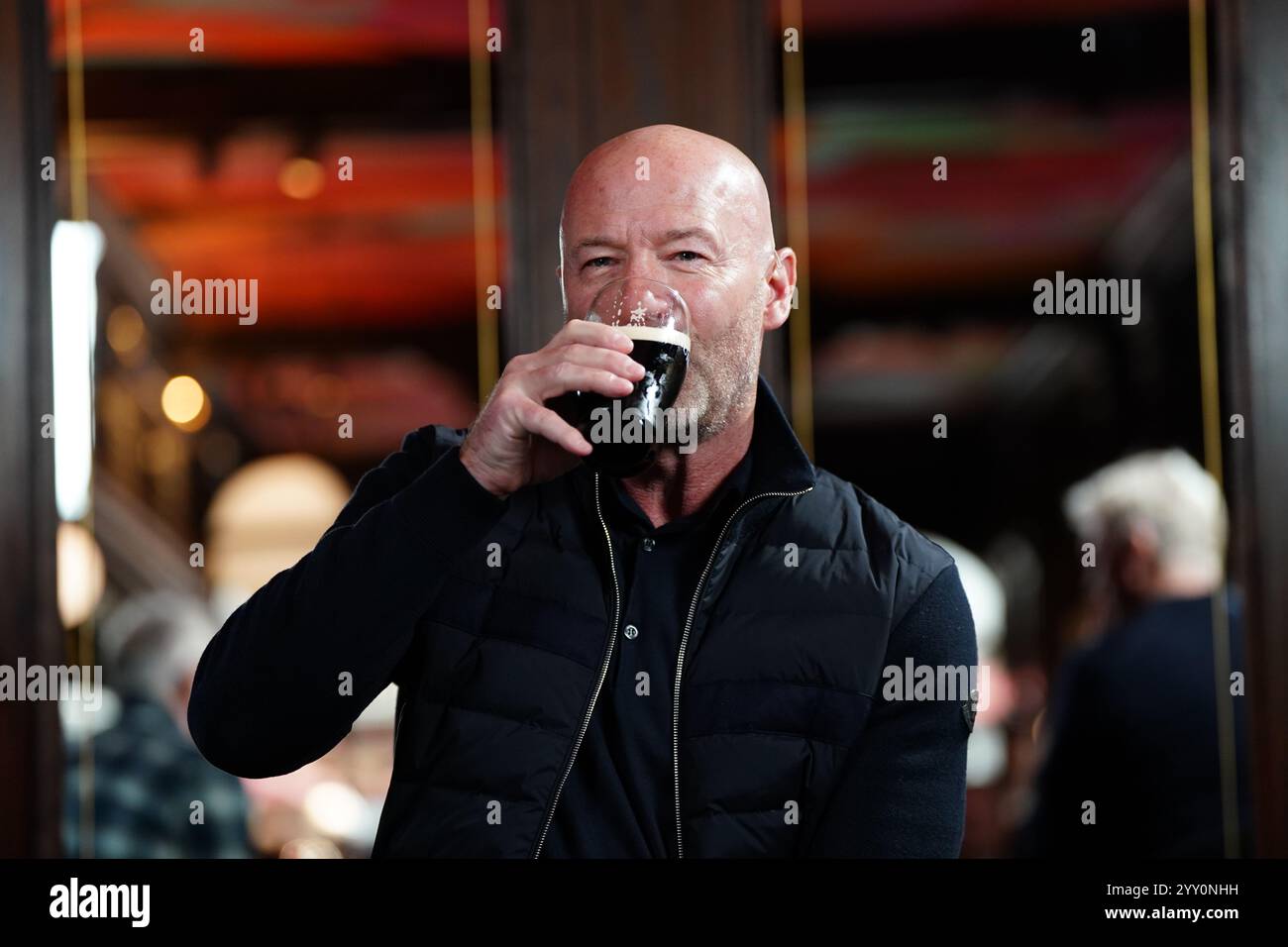 Alan Shearer takes a drink of Guinness as he records The Rest Is ...