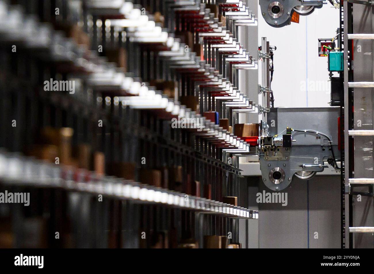 A robotic picker selects food products from a tall stack of food ...