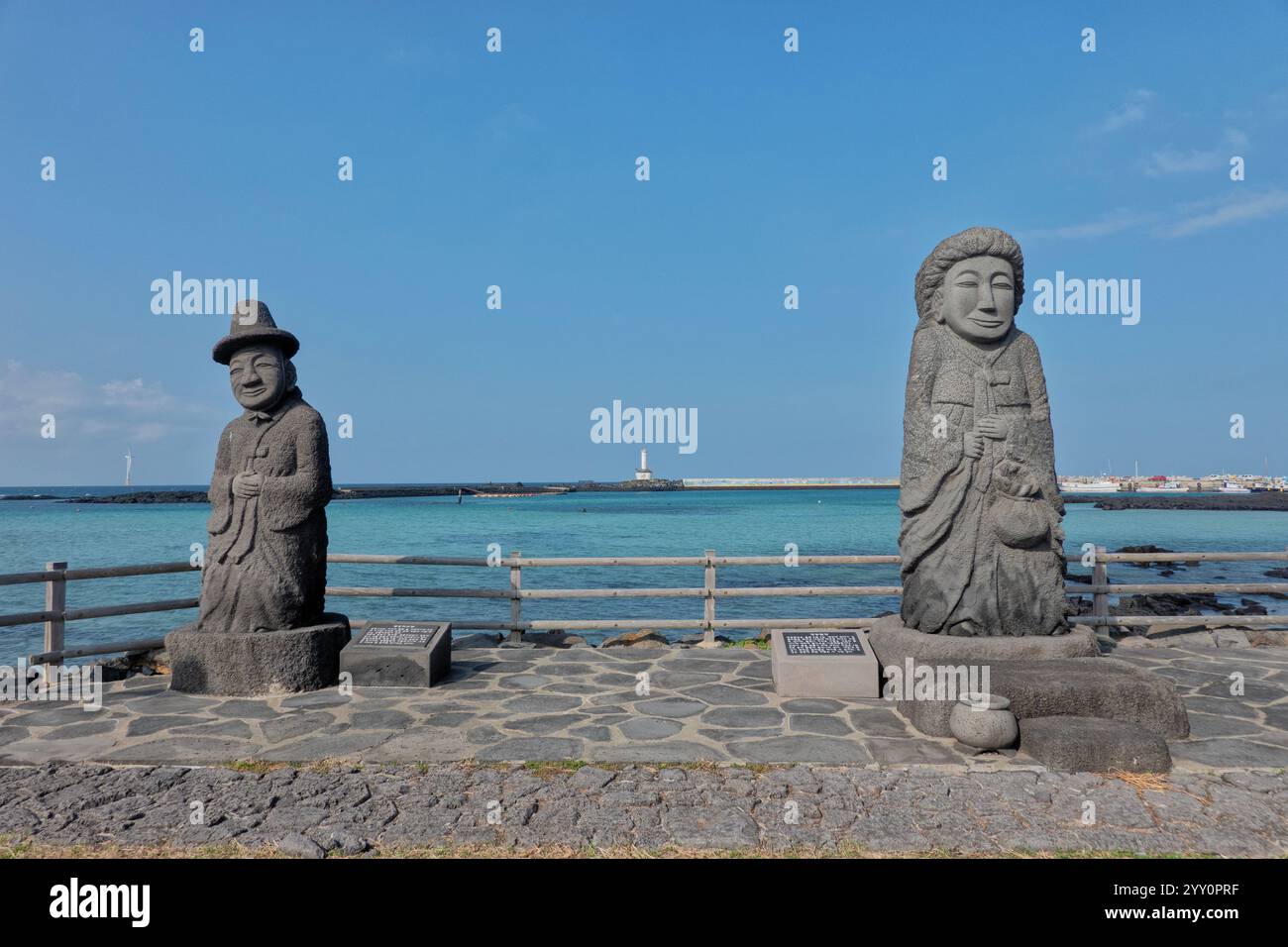Dol hareubang (grandfather stone) volcanic rock statues along the Jeju ...