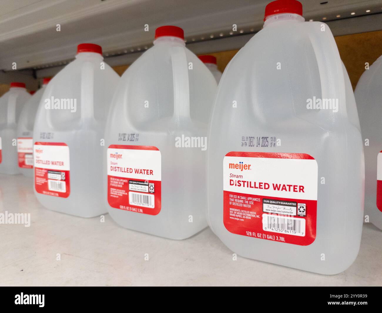 Plastic gallon jugs of distilled water on a shelf at a Meijer super ...