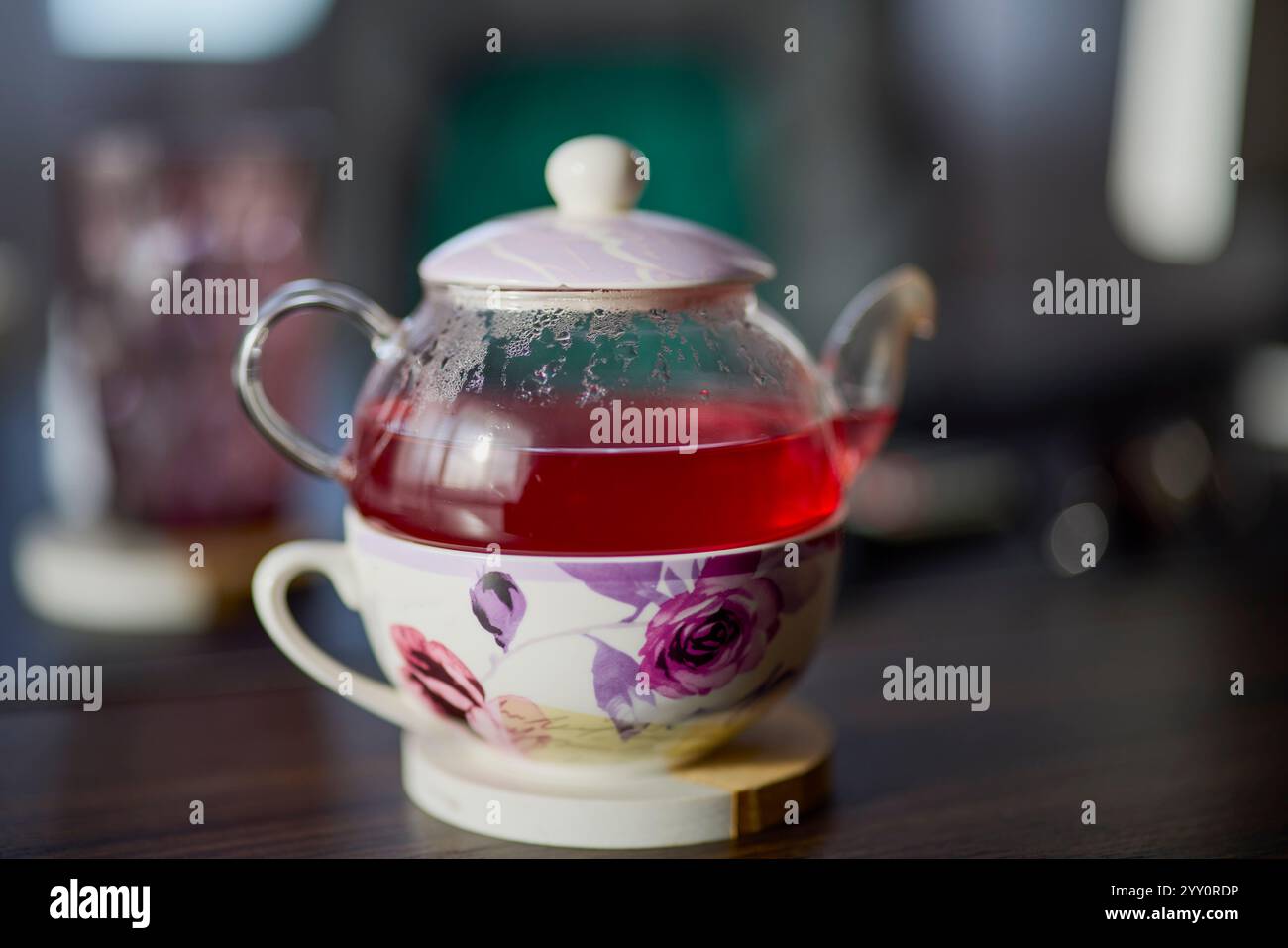 a teapot with tea on a desk with a blurred background Stock Photo - Alamy