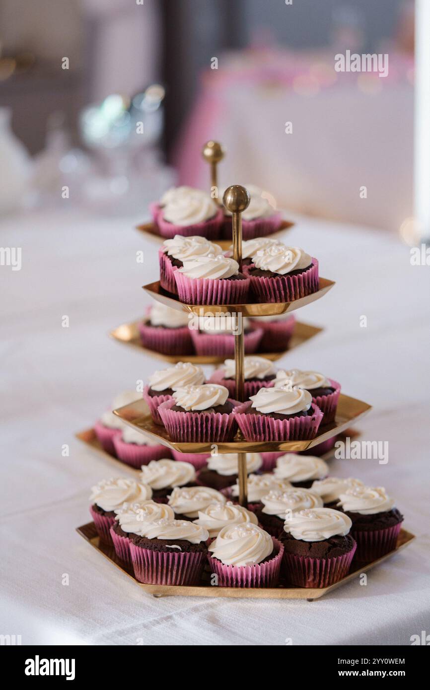 cup cakes with cream on buffet table, wedding candy bar. PINK BLUSH ...