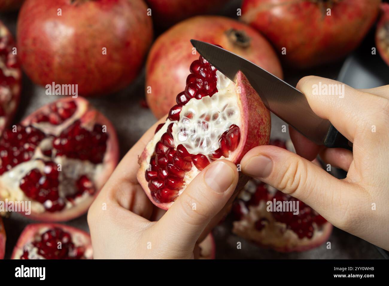The process of easily opening the pomegranate with a knife, dividing ...