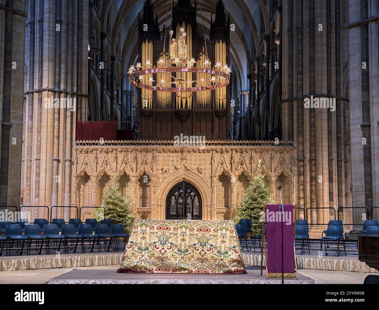 The nave with altar stone rood screen and organ pipes in the christian ...