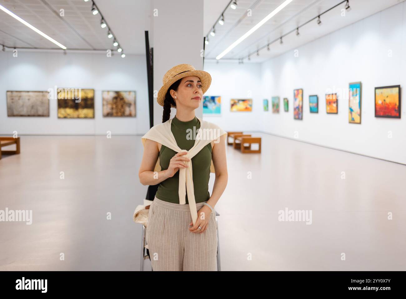 An above-the-knee portrait of a young elegantly dressed woman in a ...