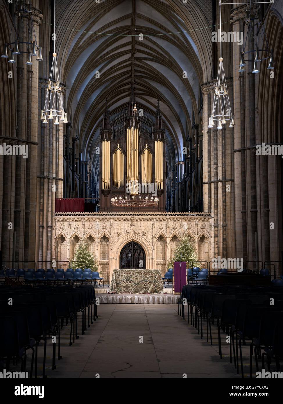 The nave, with altar, stone rood screen and organ pipes, in the ...