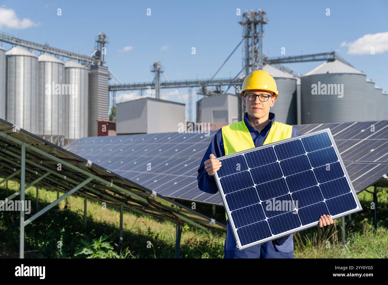 Worker with solar panel on a background of solar power station Stock ...