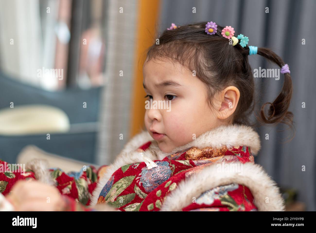 Close up portrait of cute small multiracial girl in traditional Chinese ...