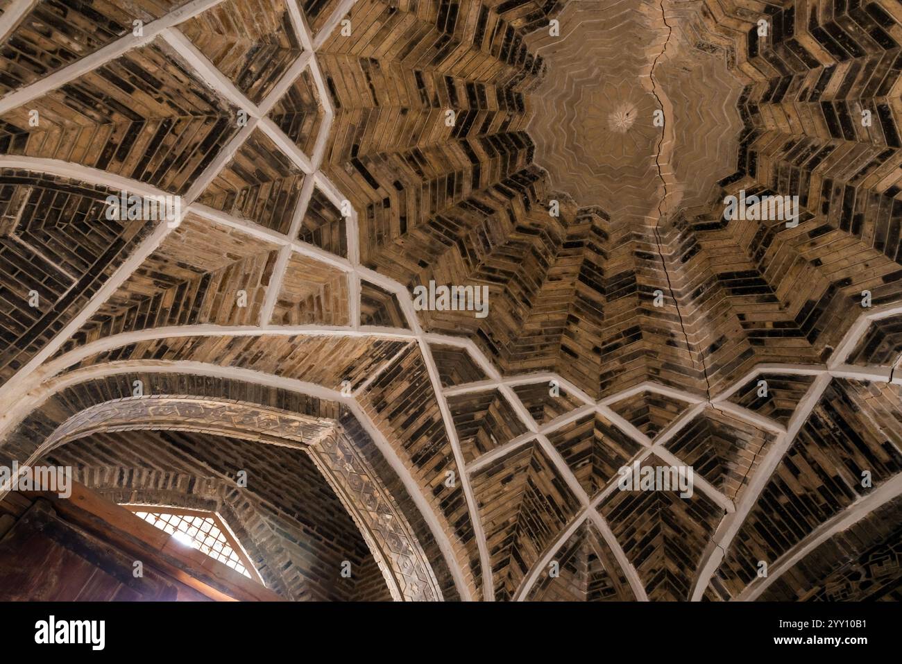 An ancient dome made of bricks with white decorative Arabic pattern ...