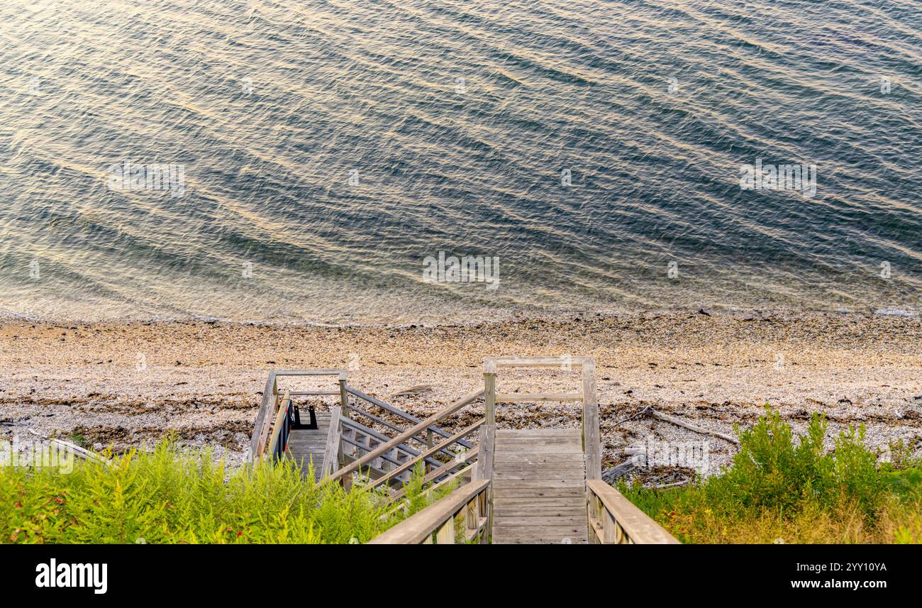 view looking down a set of stairs leading to a north fork beach Stock ...