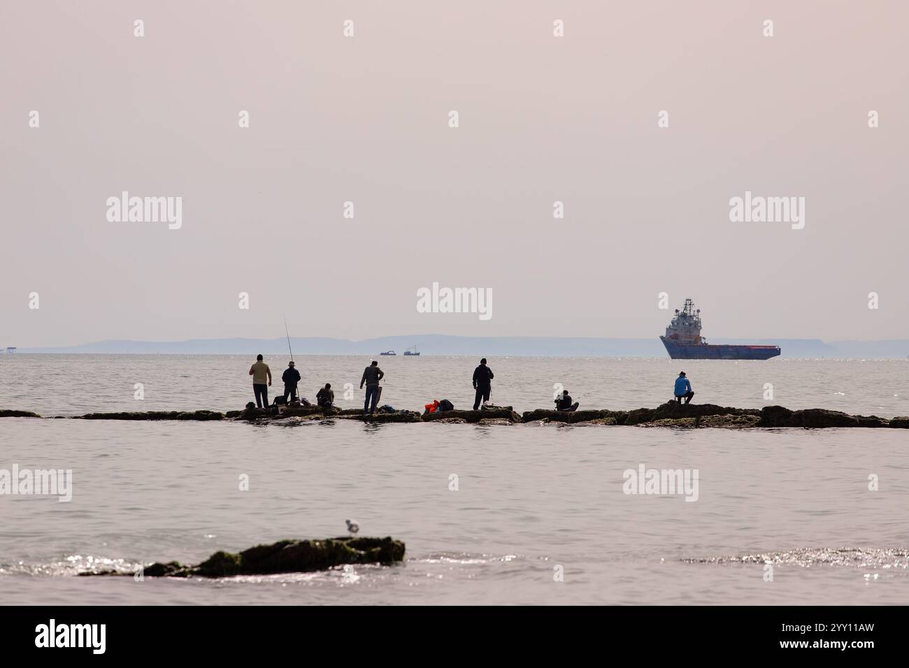 Fishermen from the ridge catch fish in the Caspian Sea. Baku ...