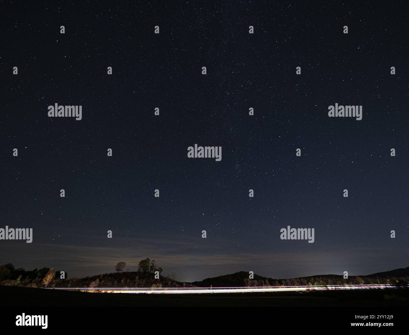 Milky Way stars, shining above the A44 motorway at night, the traffic ...